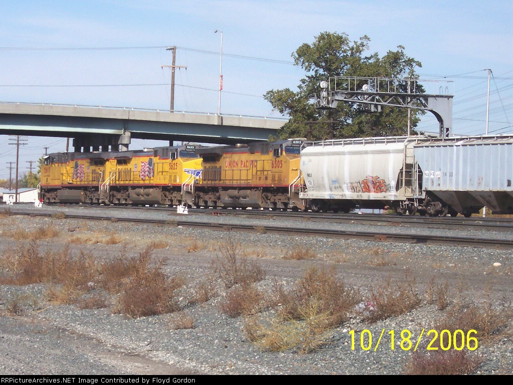 UP 6505, PMLX 1126, NAHX 487439 in UP Covered Hopper unit train.